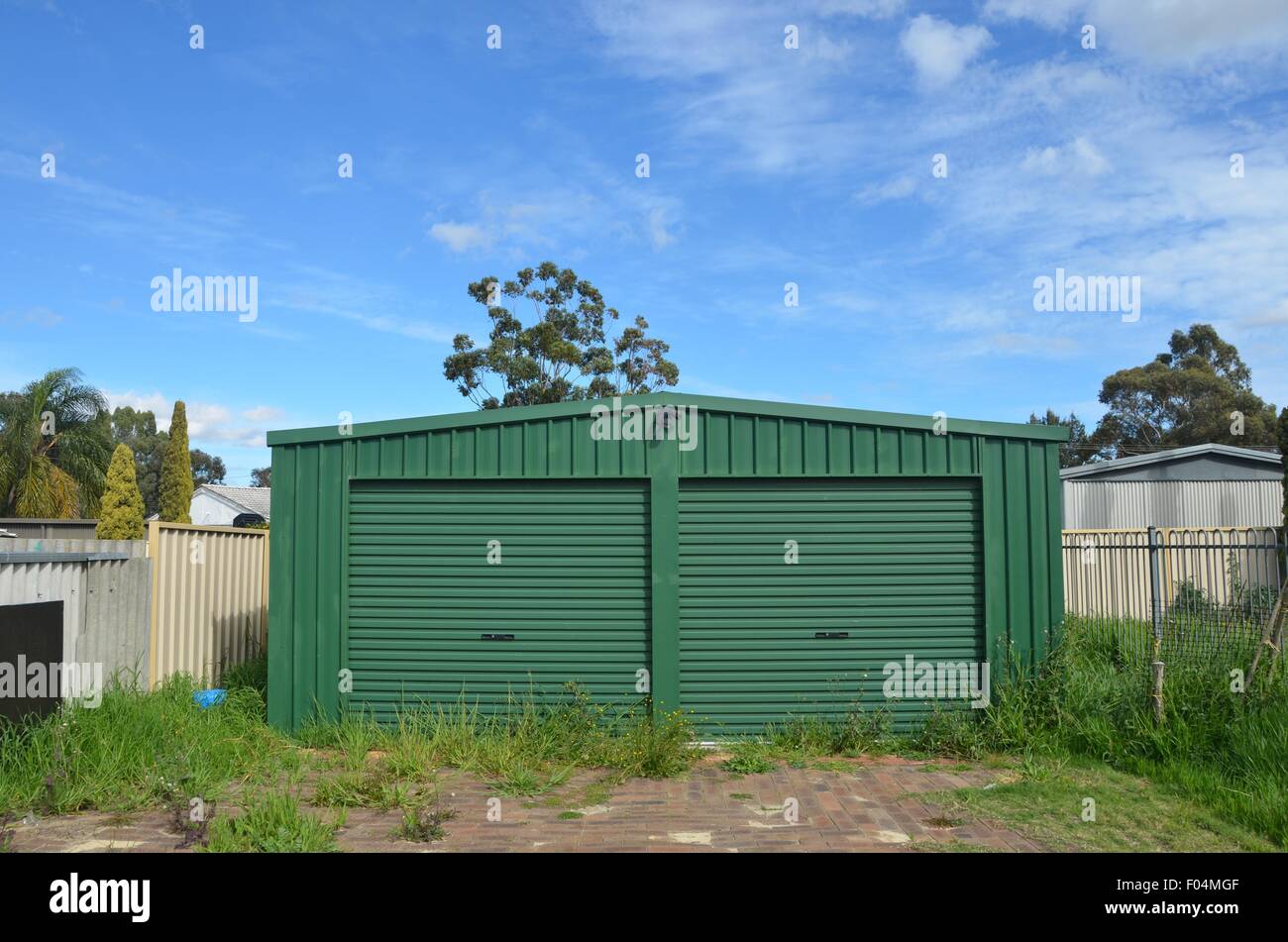 Blue sky behind green garage Stock Photo - Alamy