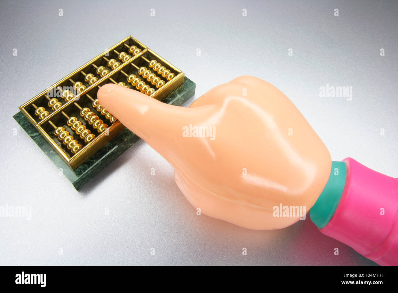 Plastic Hand with Miniature Abacus Stock Photo - Alamy
