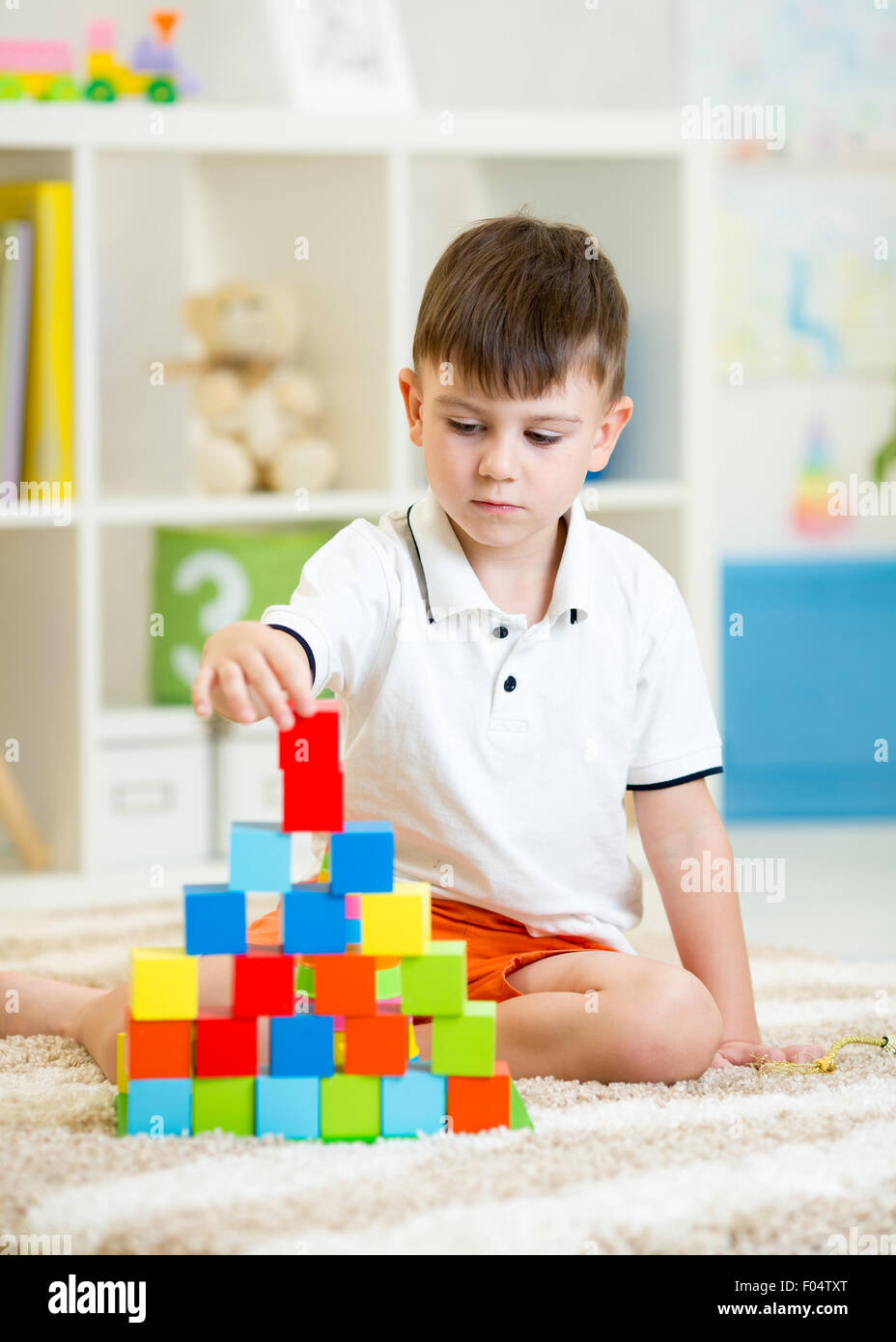 Child playing with blocks in the kindergarten Stock Photo - Alamy