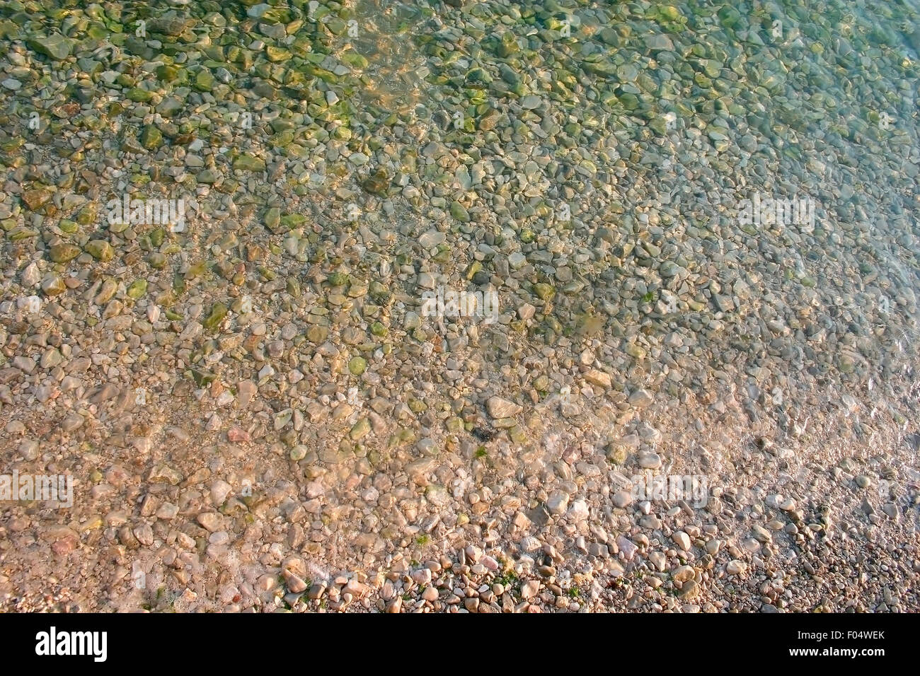Turquoise pebble coast line Stock Photo - Alamy