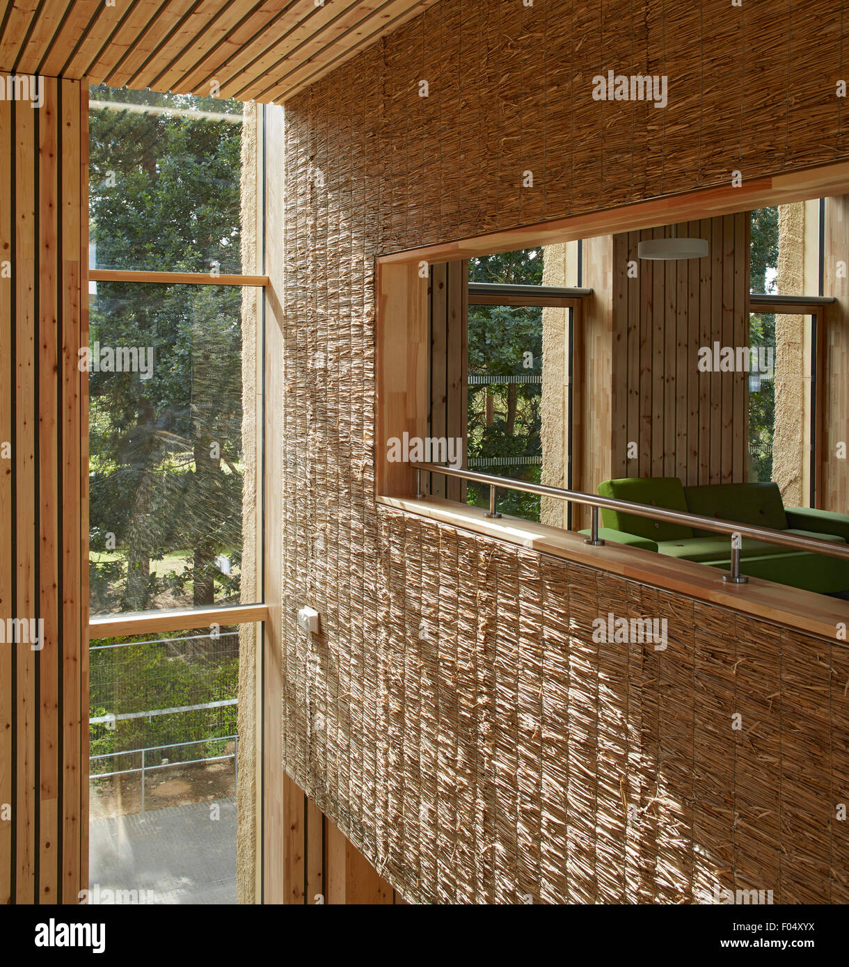 Acoustic thatch paneling and fenestration on first floor. The ...