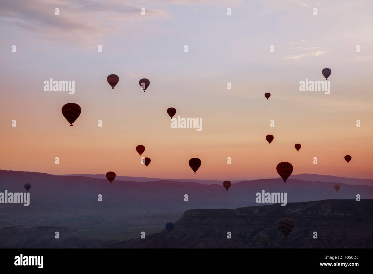 Hot air balloons flying up in the sky in silhouettes Stock Photo - Alamy