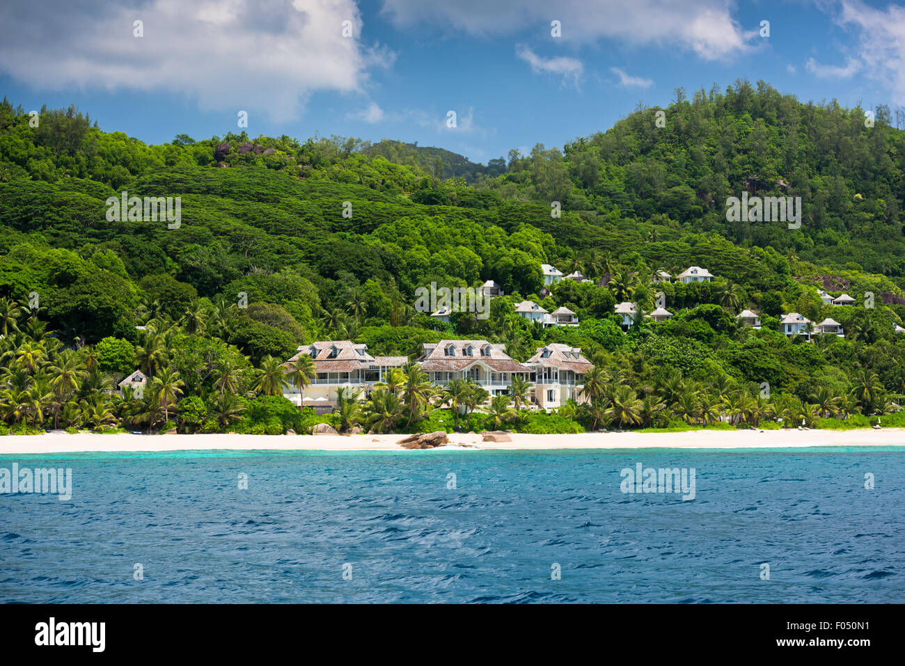View of Seychelles coastline with a house in the forest. Horizontal ...