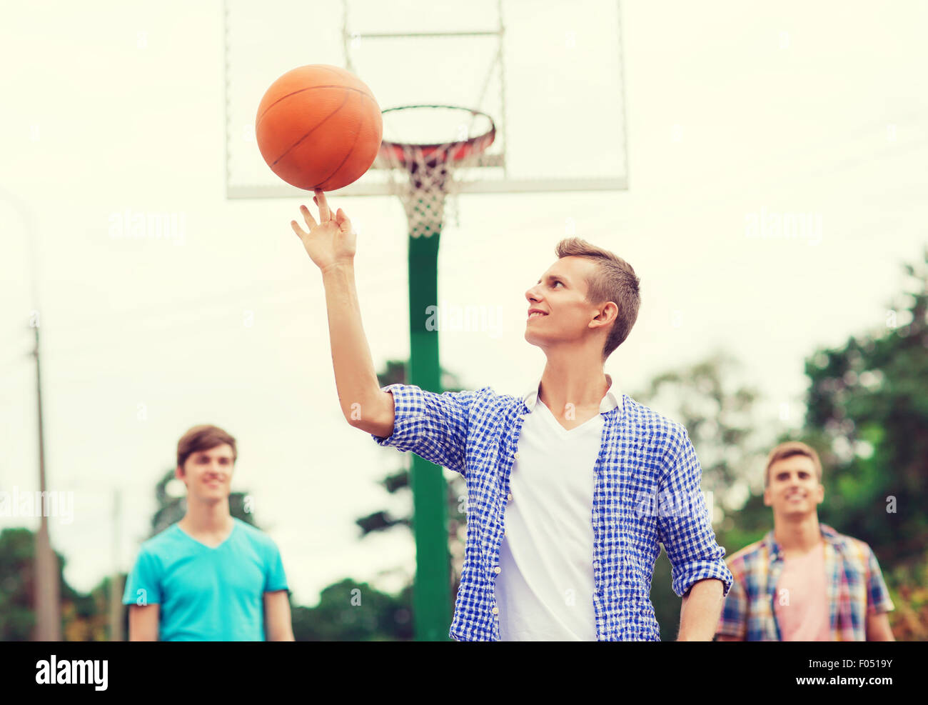 group of smiling teenagers playing basketball Stock Photo - Alamy