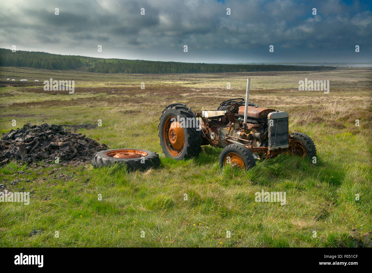 Peat diggings and ancient tractor on the Commitee road North Uist Outer ...