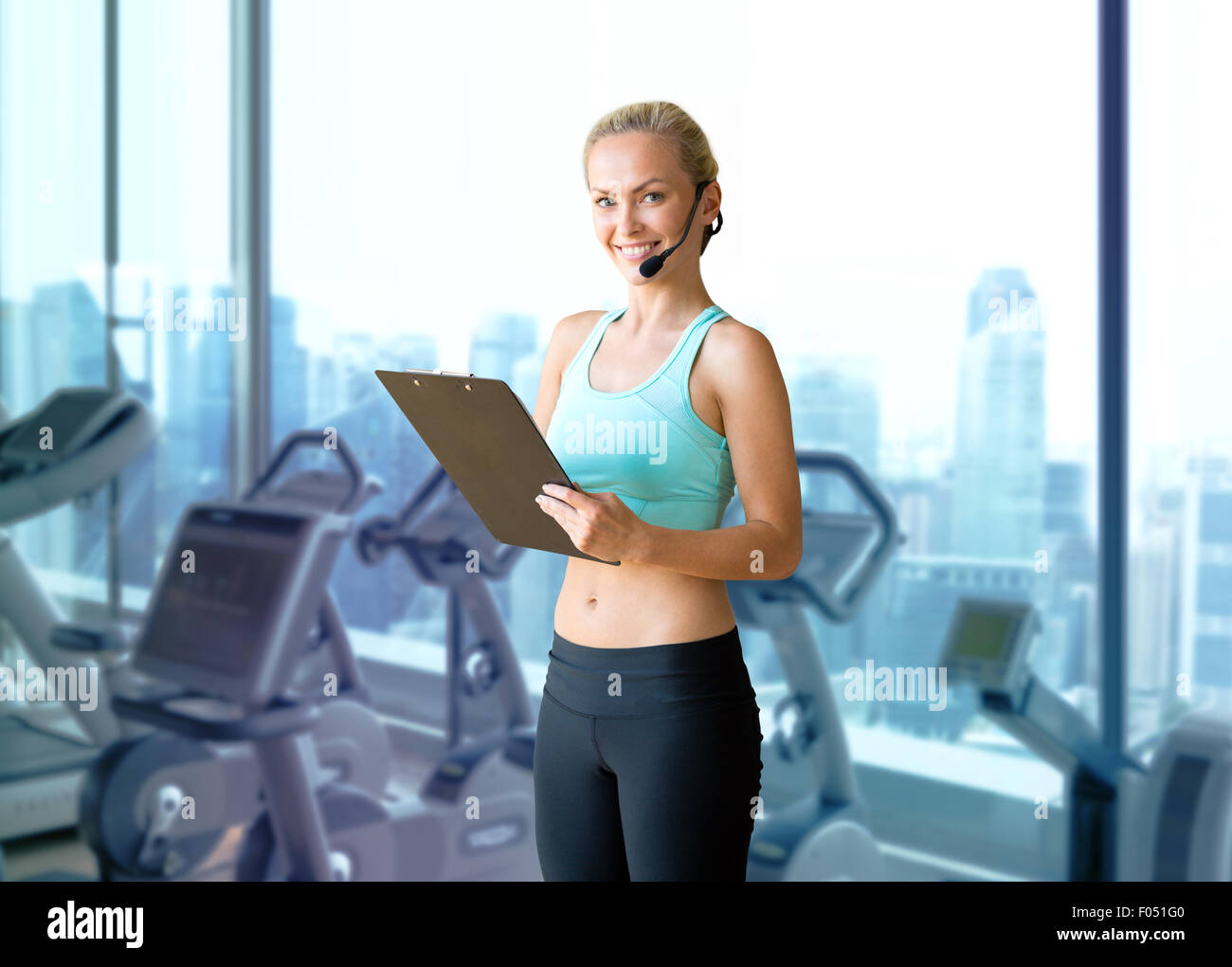 happy woman trainer with microphone and clipboard Stock Photo - Alamy