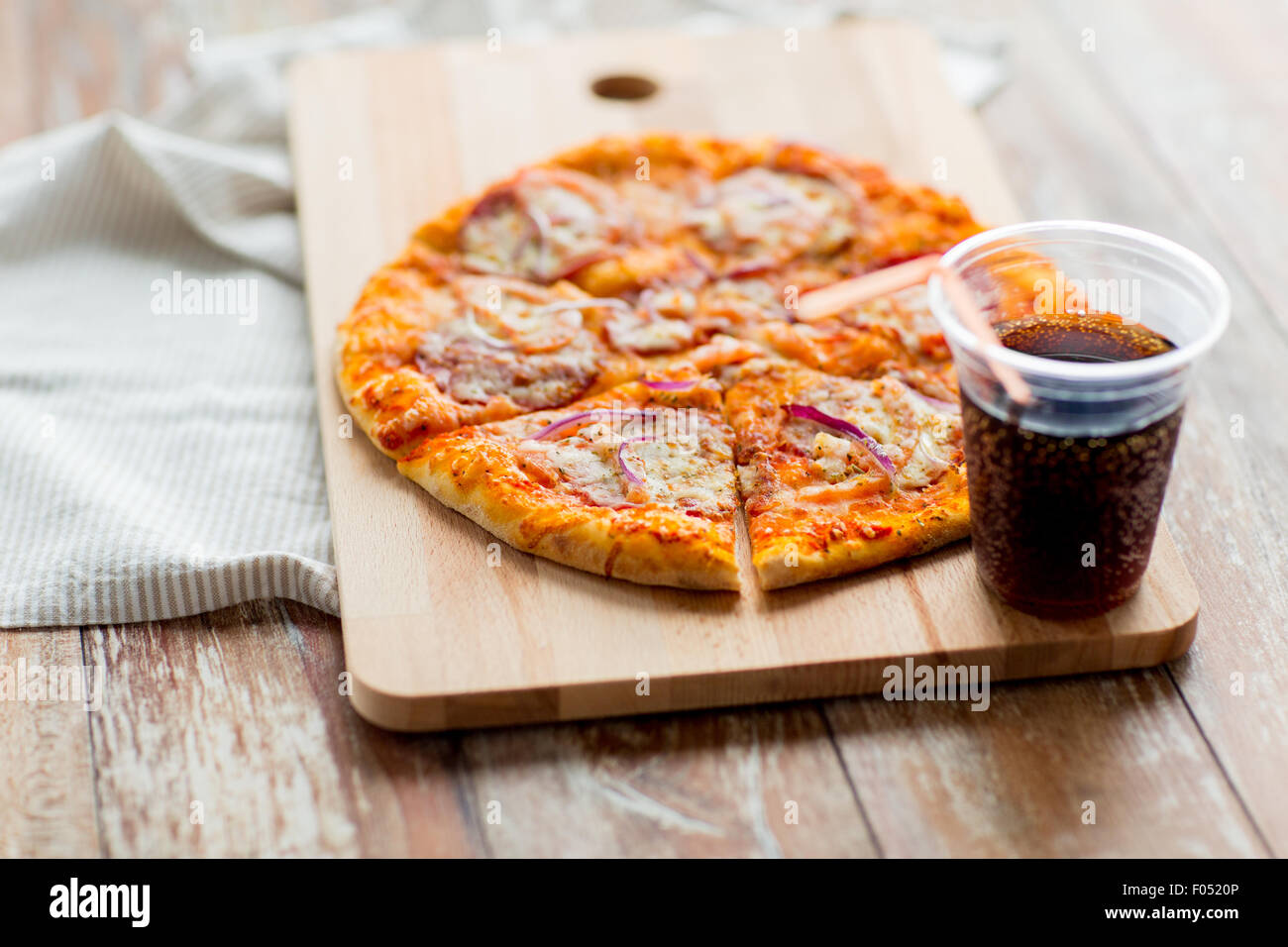 close up of pizza with coca cola on table Stock Photo - Alamy
