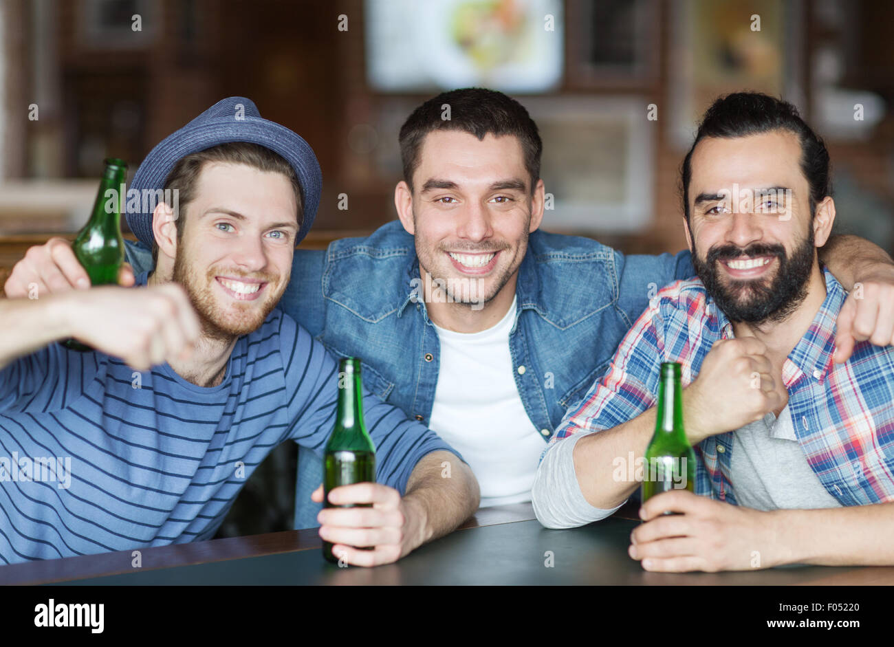 happy male friends drinking beer at bar or pub Stock Photo - Alamy