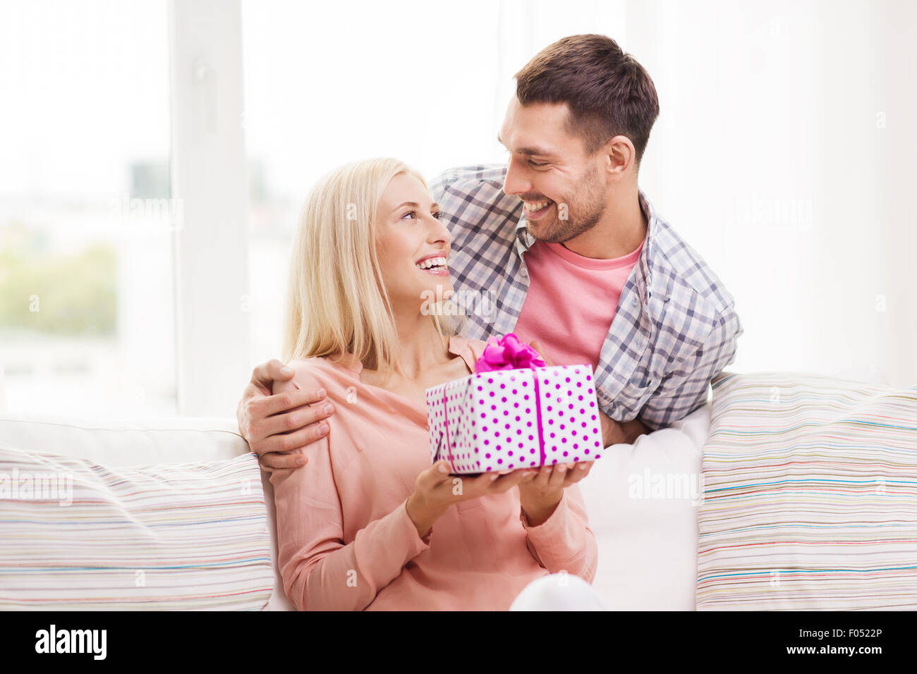 happy man giving woman gift box at home Stock Photo - Alamy