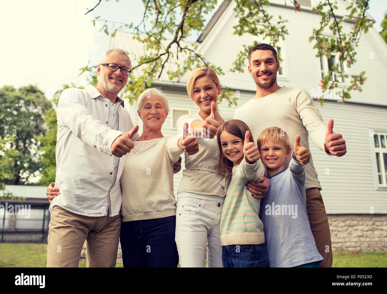 happy family in front of house outdoors Stock Photo - Alamy