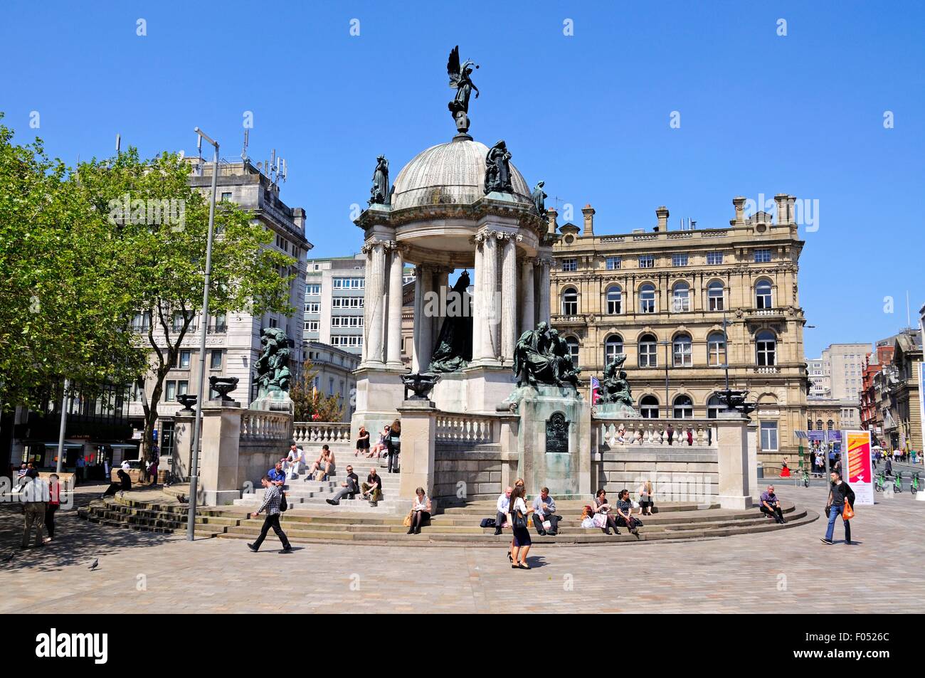The Queen Victoria monument in Derby Square with tourists sitting on ...