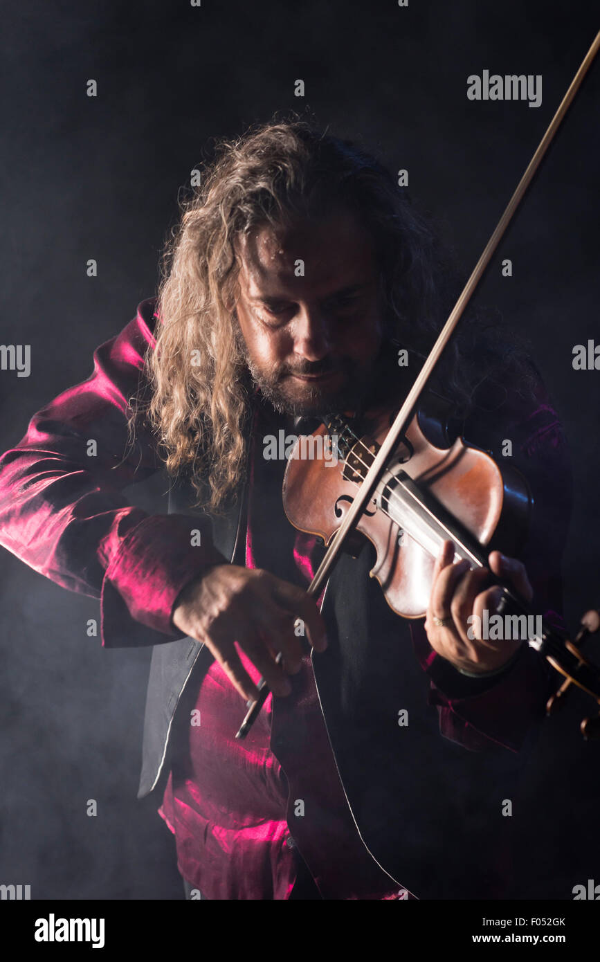 handsome man playing classical violin through blue smoke Stock Photo ...