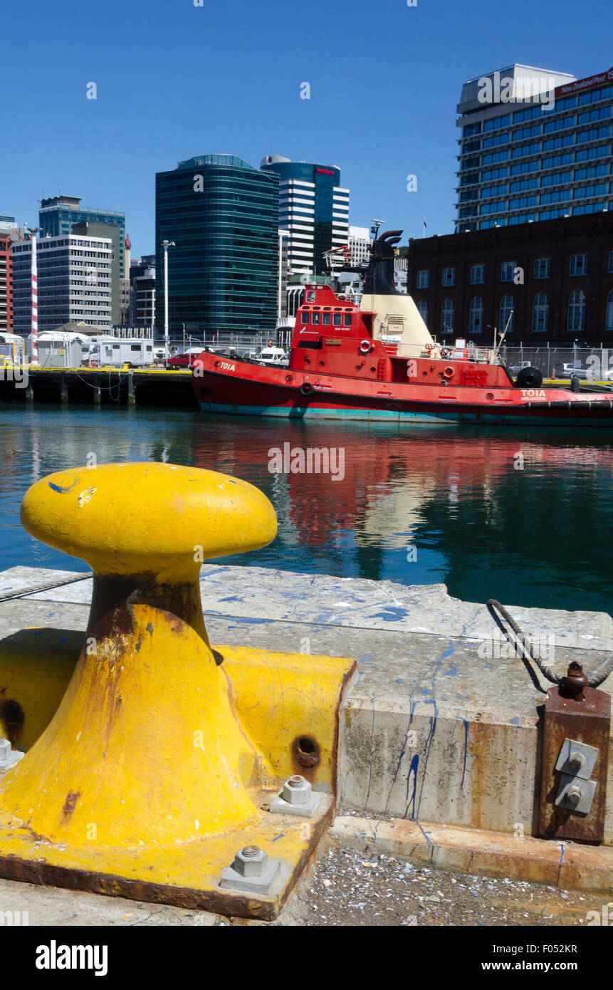Red tug boat at port, Office buildings and CBD behind, Wellington ...