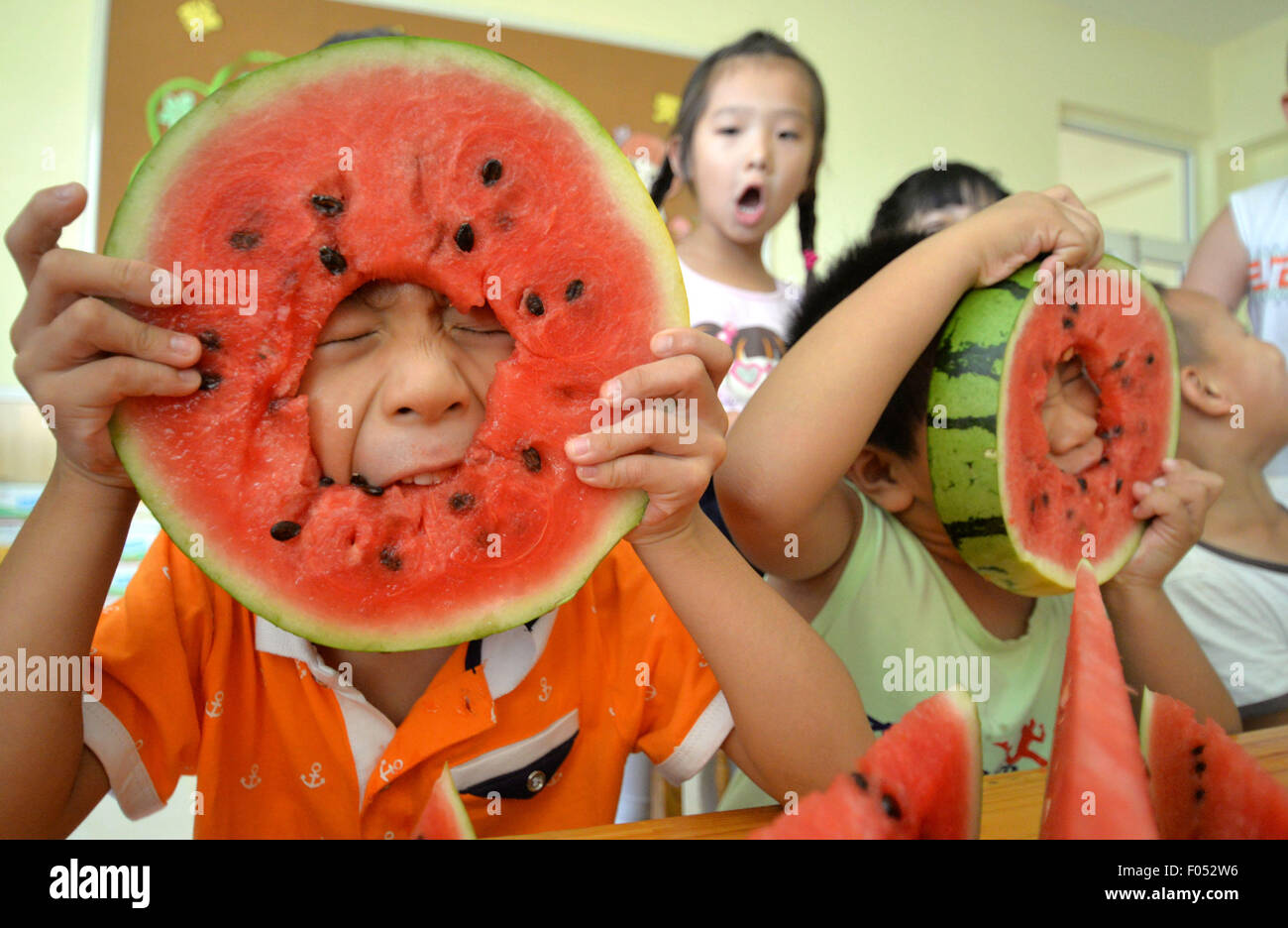 Handan, China's Hebei Province. 7th Aug, 2015. Children eat watermelons ...
