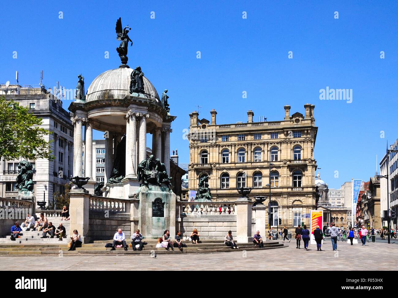 The Queen Victoria monument in Derby Square with tourists sitting on ...