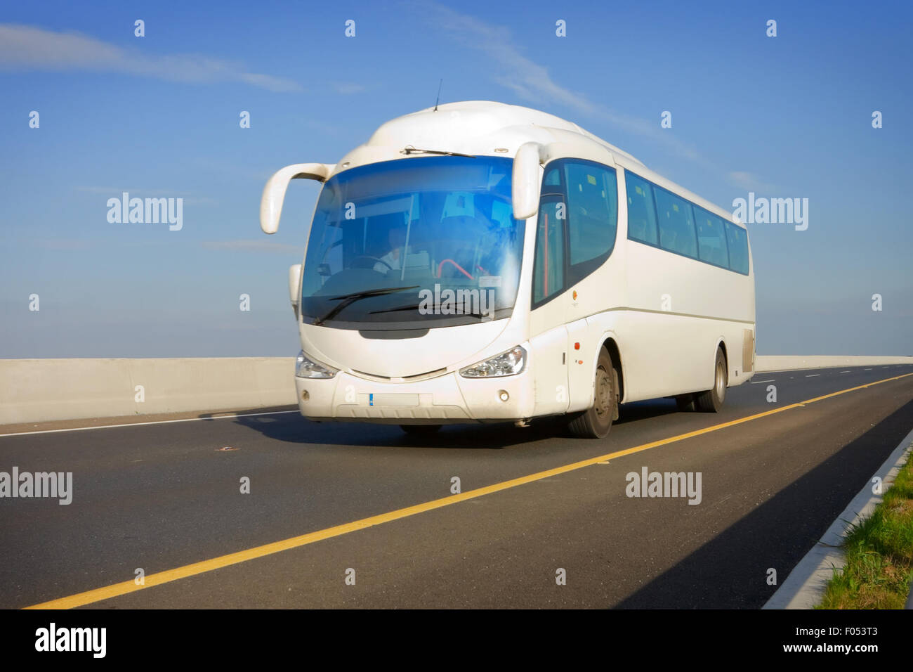 white tourist bus on the highway and blue sky Stock Photo - Alamy