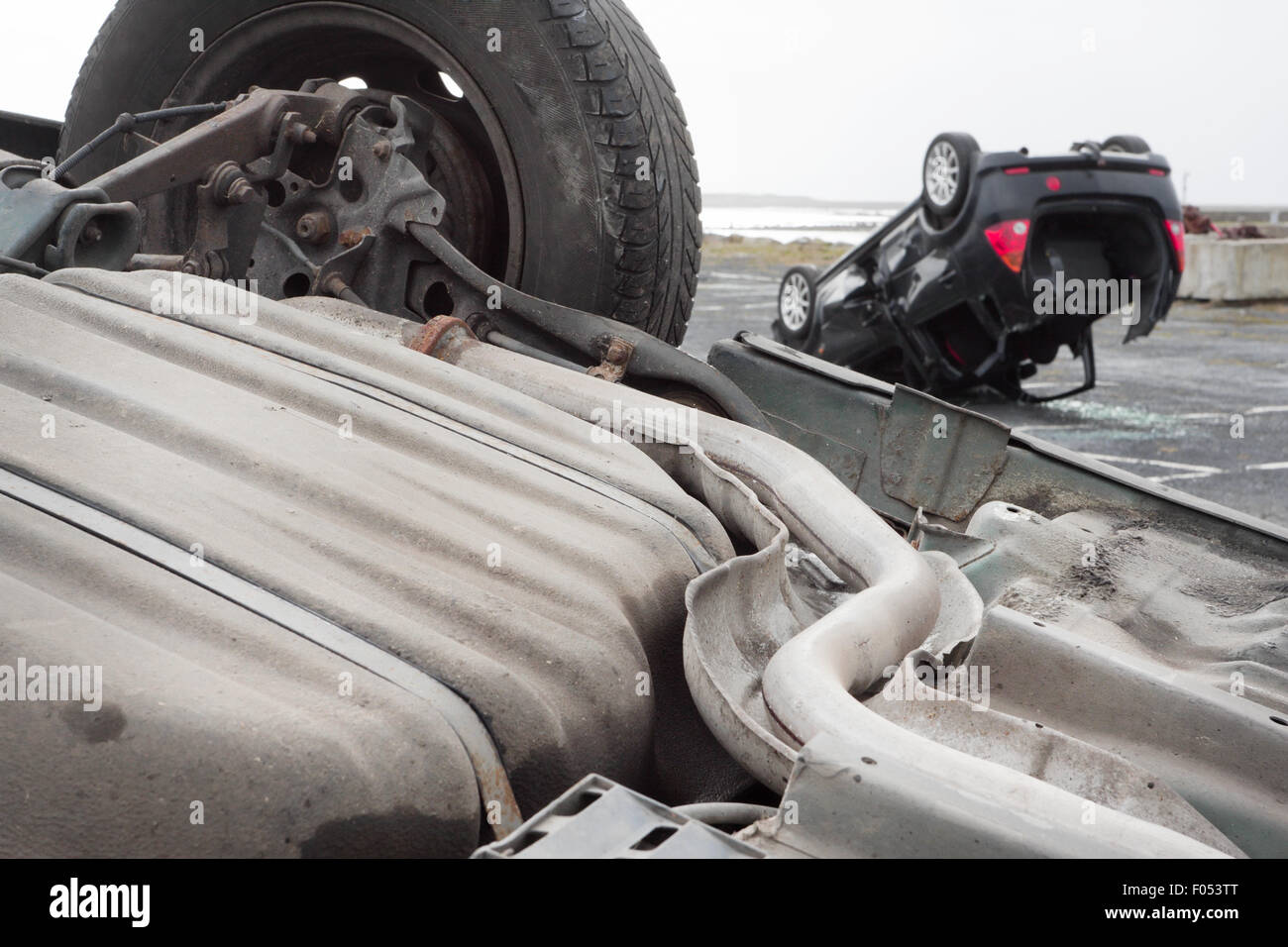 two cars turned upside-down after road collision Stock Photo - Alamy