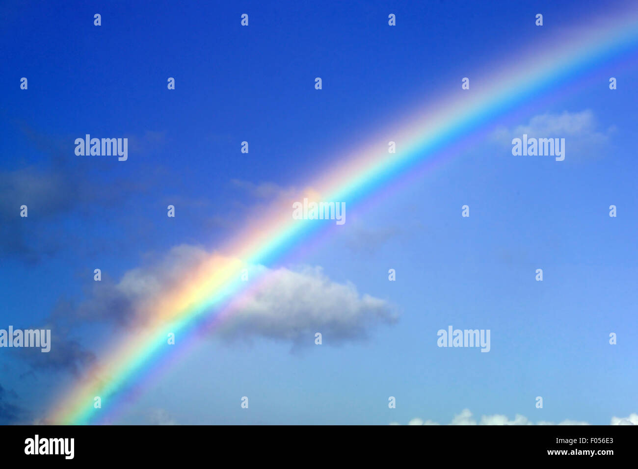 Rainbow in blue sky Stock Photo - Alamy