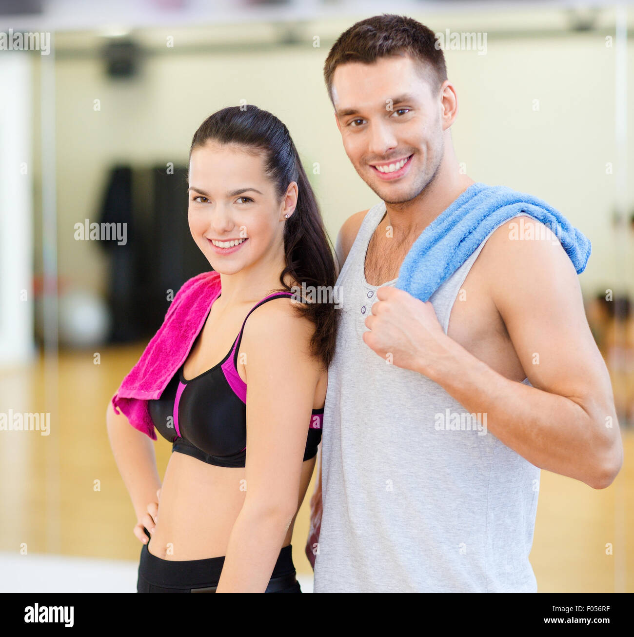 two smiling people in the gym Stock Photo - Alamy