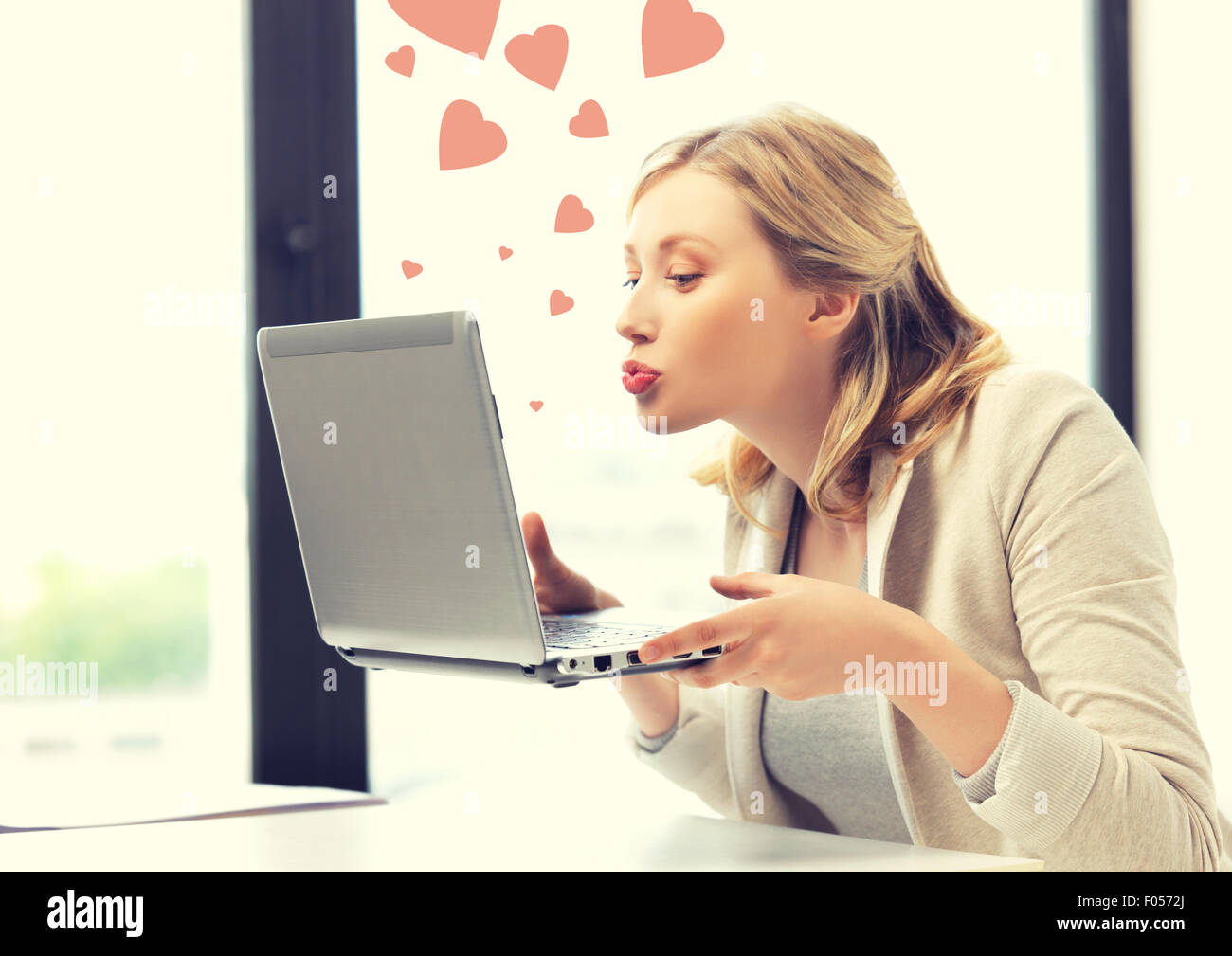woman with computer kissing the screen Stock Photo - Alamy