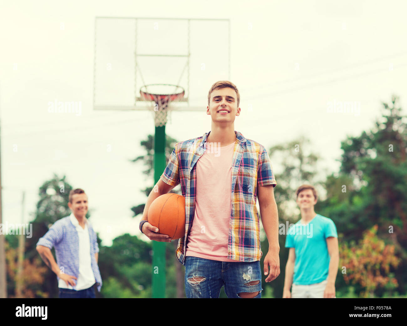 Group happy teenagers playing basketball hi-res stock photography and ...
