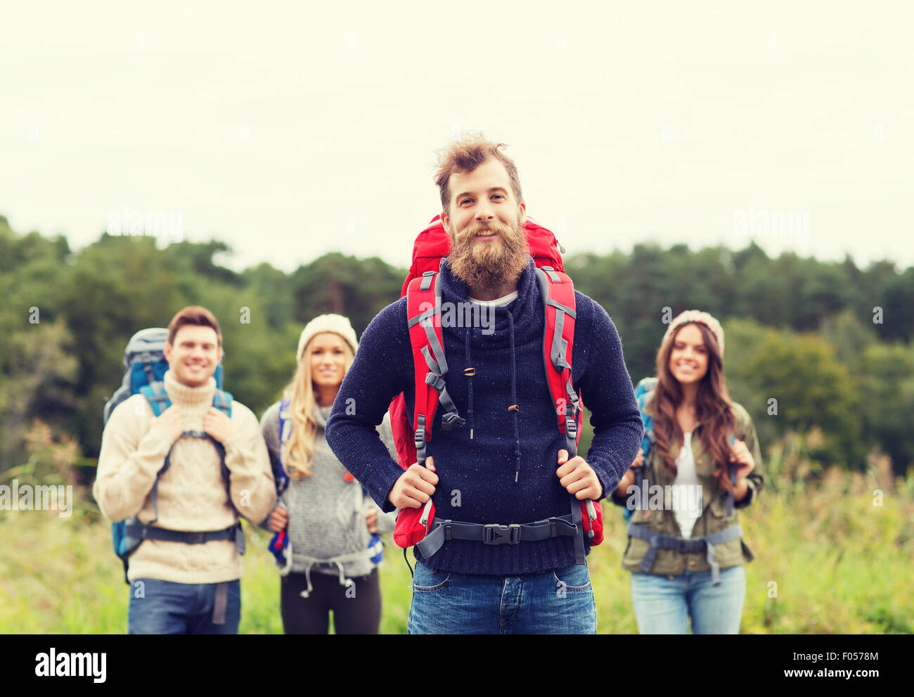 group of smiling friends with backpacks hiking Stock Photo - Alamy