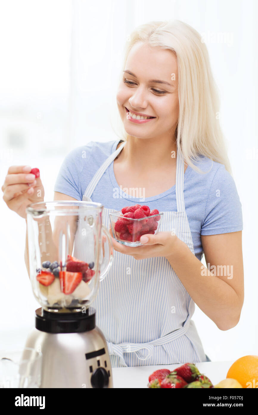 smiling woman with blender preparing shake at home Stock Photo - Alamy