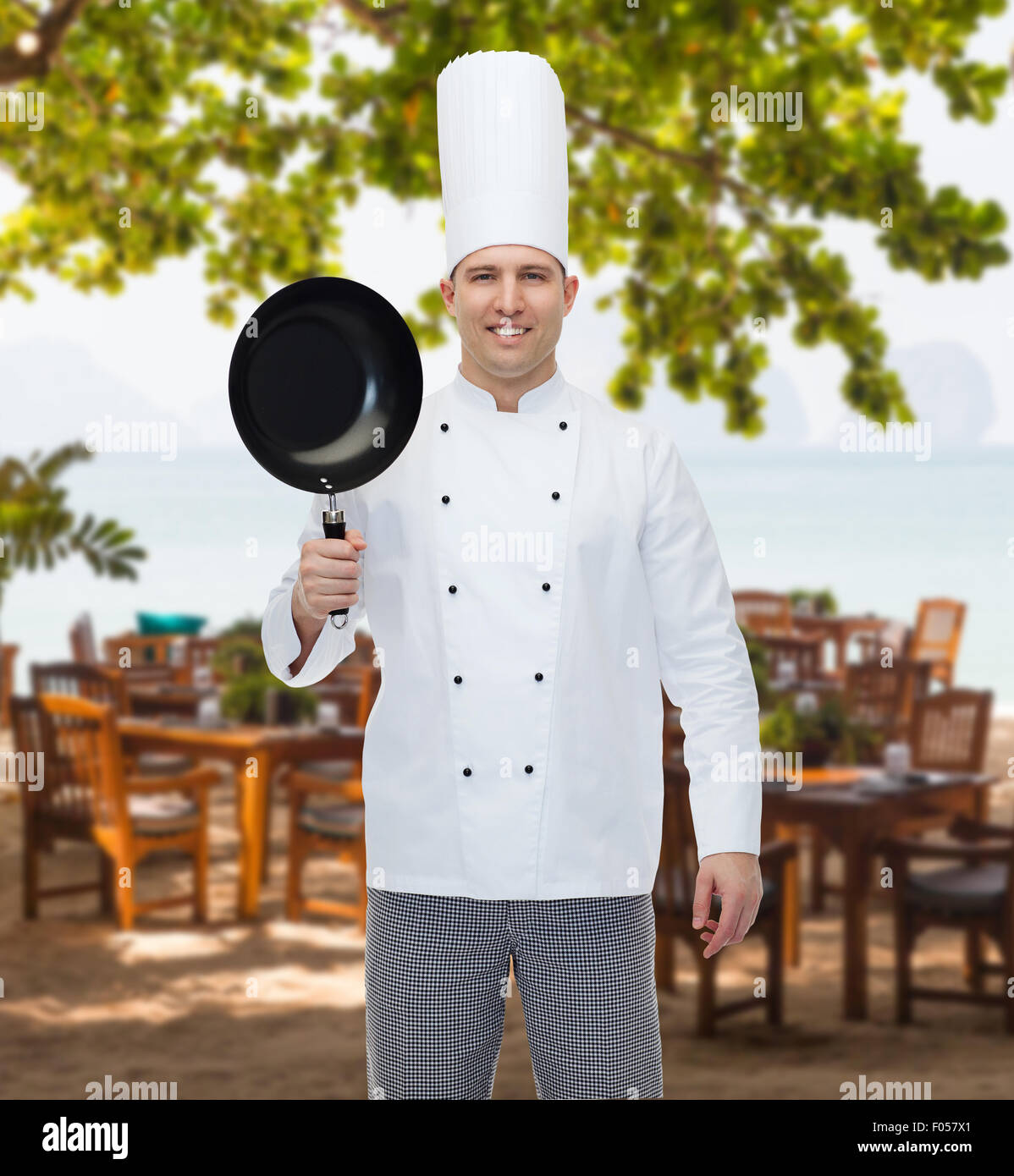 happy male chef cook holding frying pan Stock Photo - Alamy