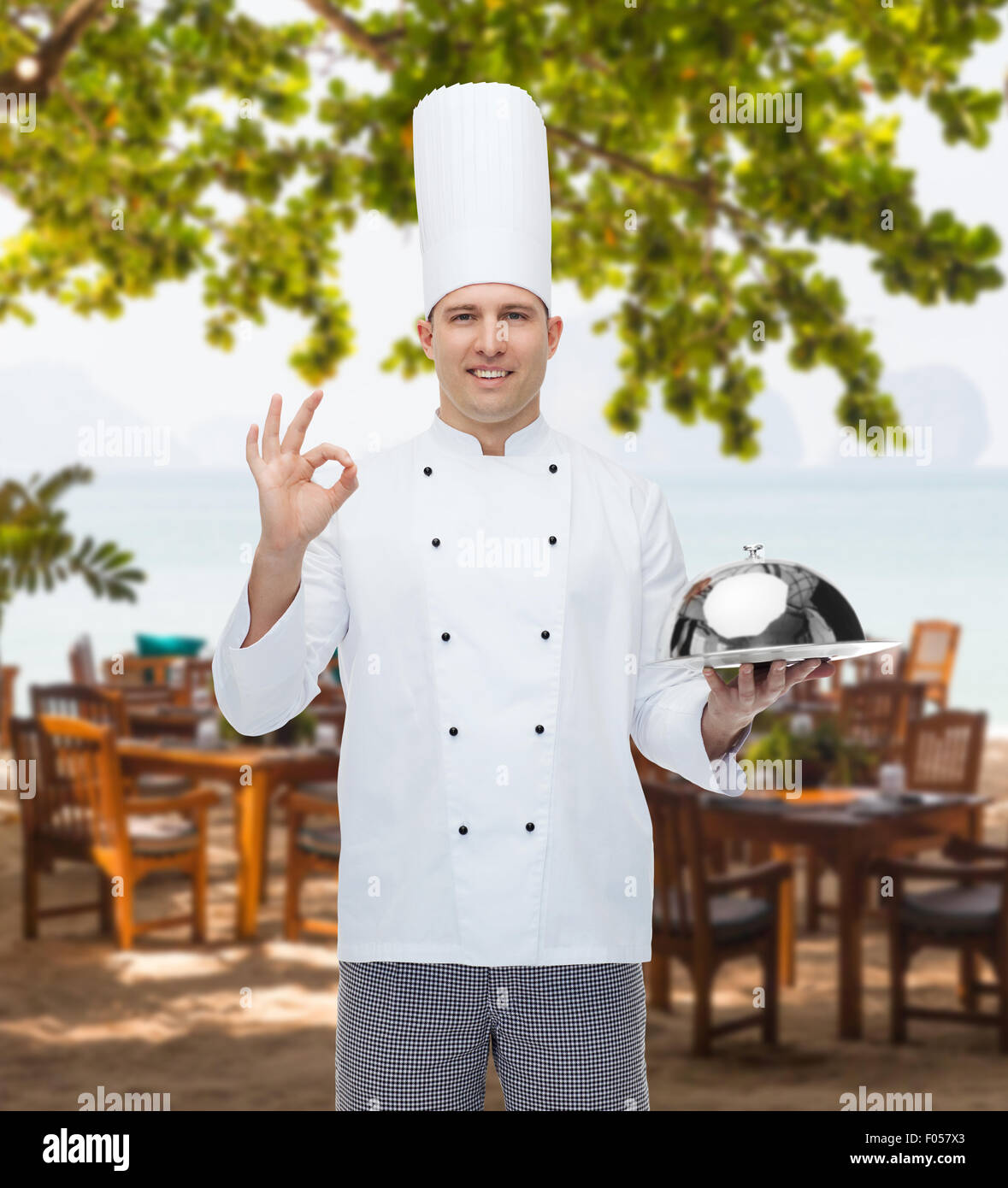 happy male chef cook with cloche showing ok sign Stock Photo - Alamy