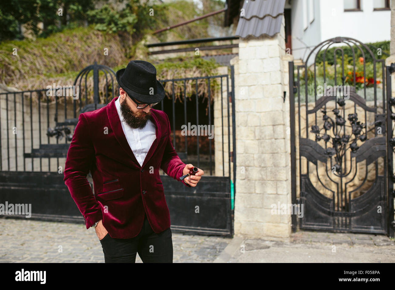 a rich man in a jacket near his house Stock Photo - Alamy