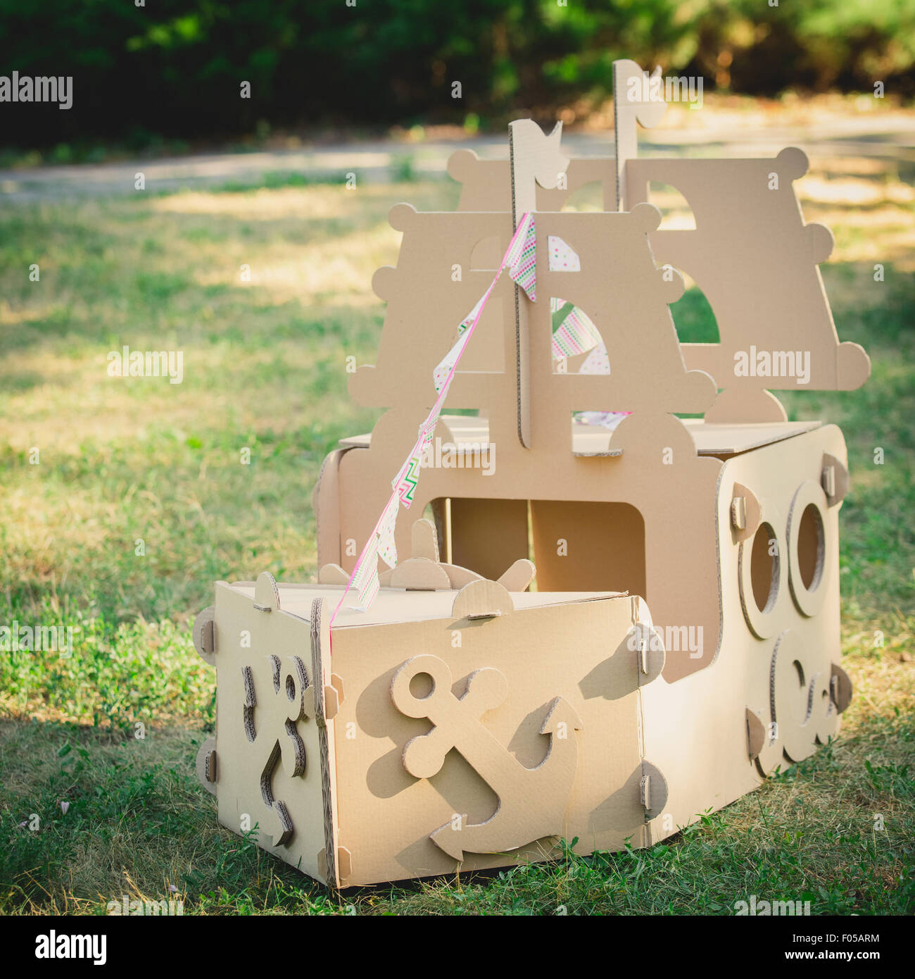 Cardboard toy boat in the park. Eco concept Stock Photo - Alamy
