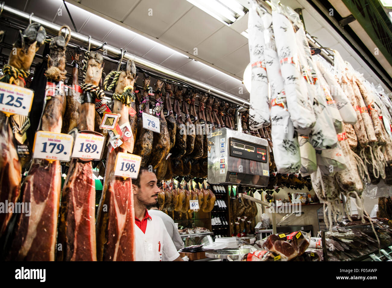 Jamon Iberico, spanish ham, hanging at local butcher in Boqueria market ...