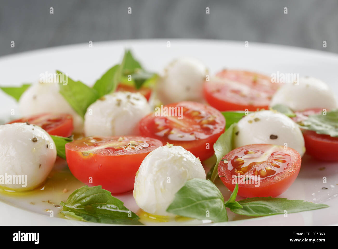 caprese salad with mini mozzarella balls and tomatoes Stock Photo - Alamy