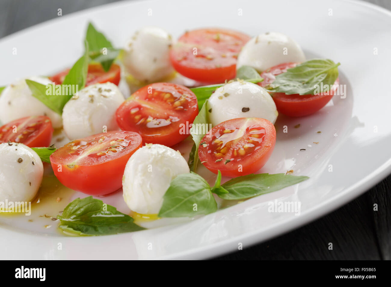 caprese salad with mini mozzarella balls and tomatoes Stock Photo - Alamy