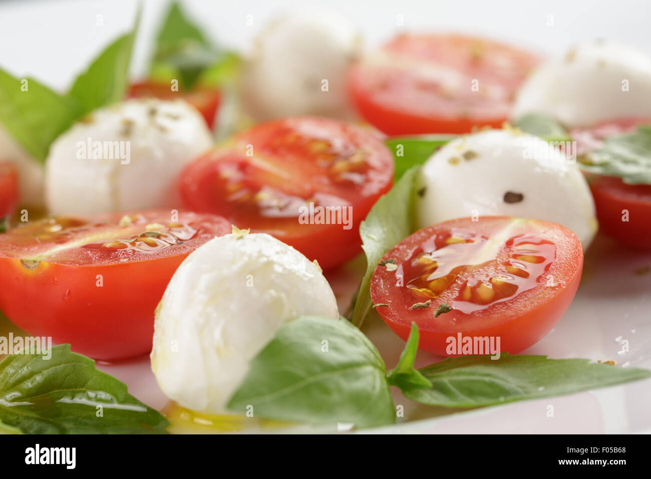 caprese salad with mini mozzarella balls and tomatoes Stock Photo - Alamy