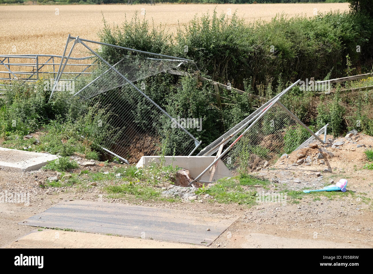 fencing around a drainage ditch that as blown over Stock Photo - Alamy