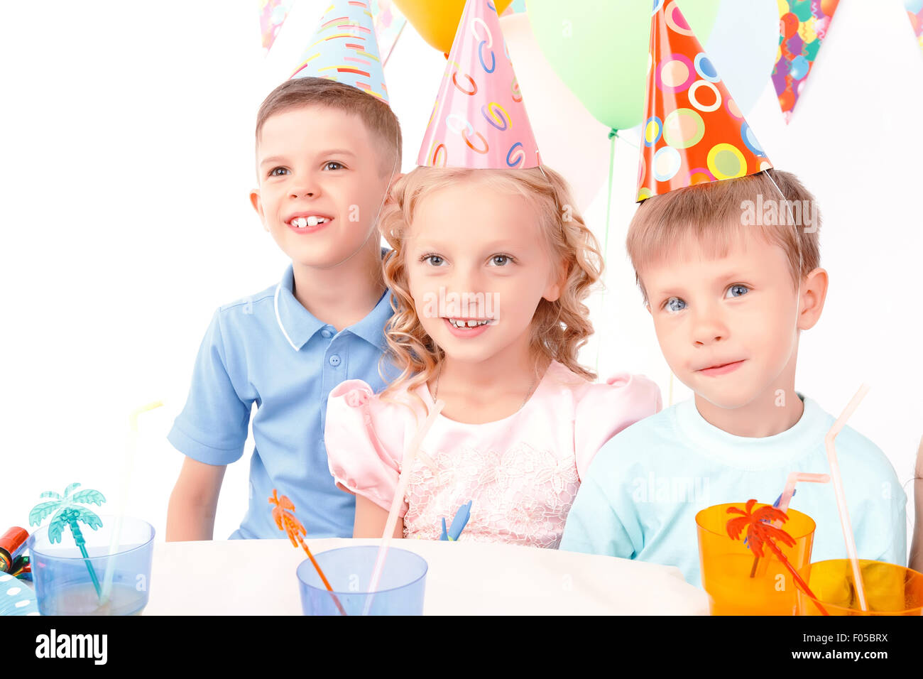 Three little kids posing during birthday party Stock Photo - Alamy