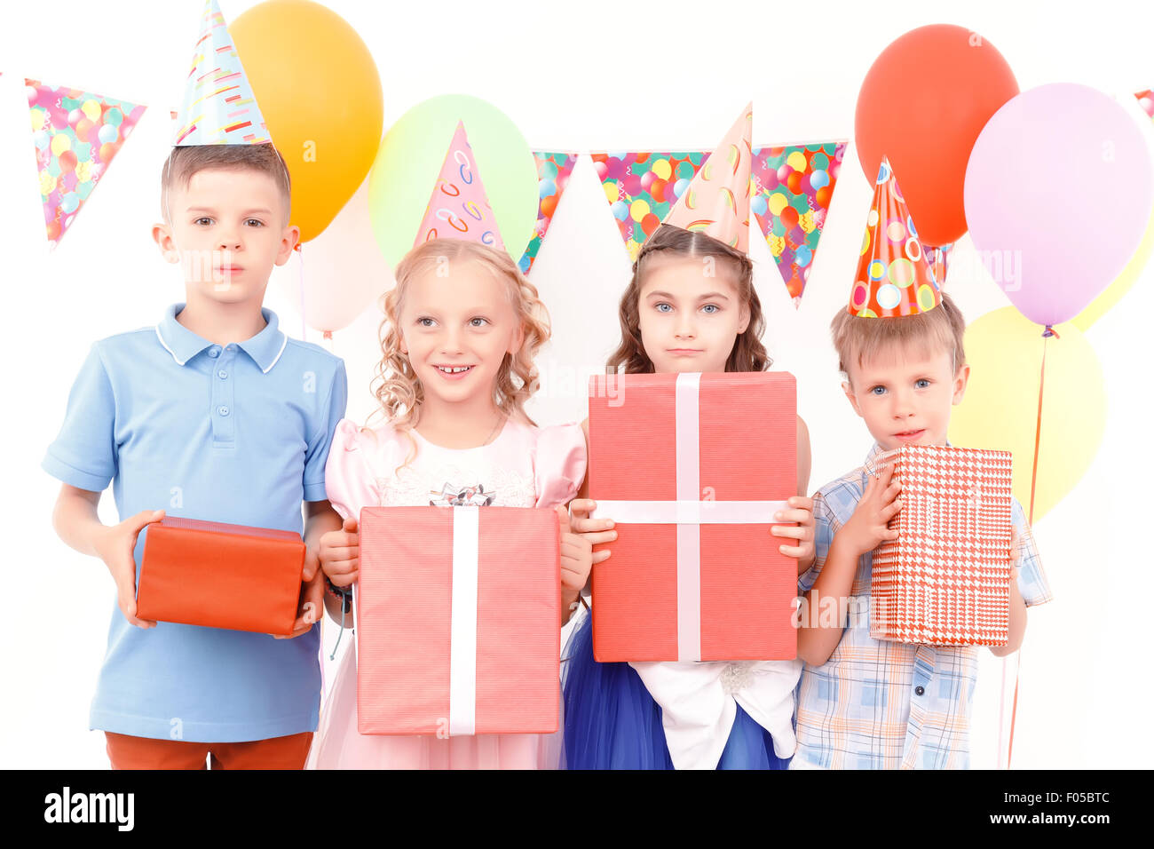 Little children posing with birthday presents Stock Photo - Alamy