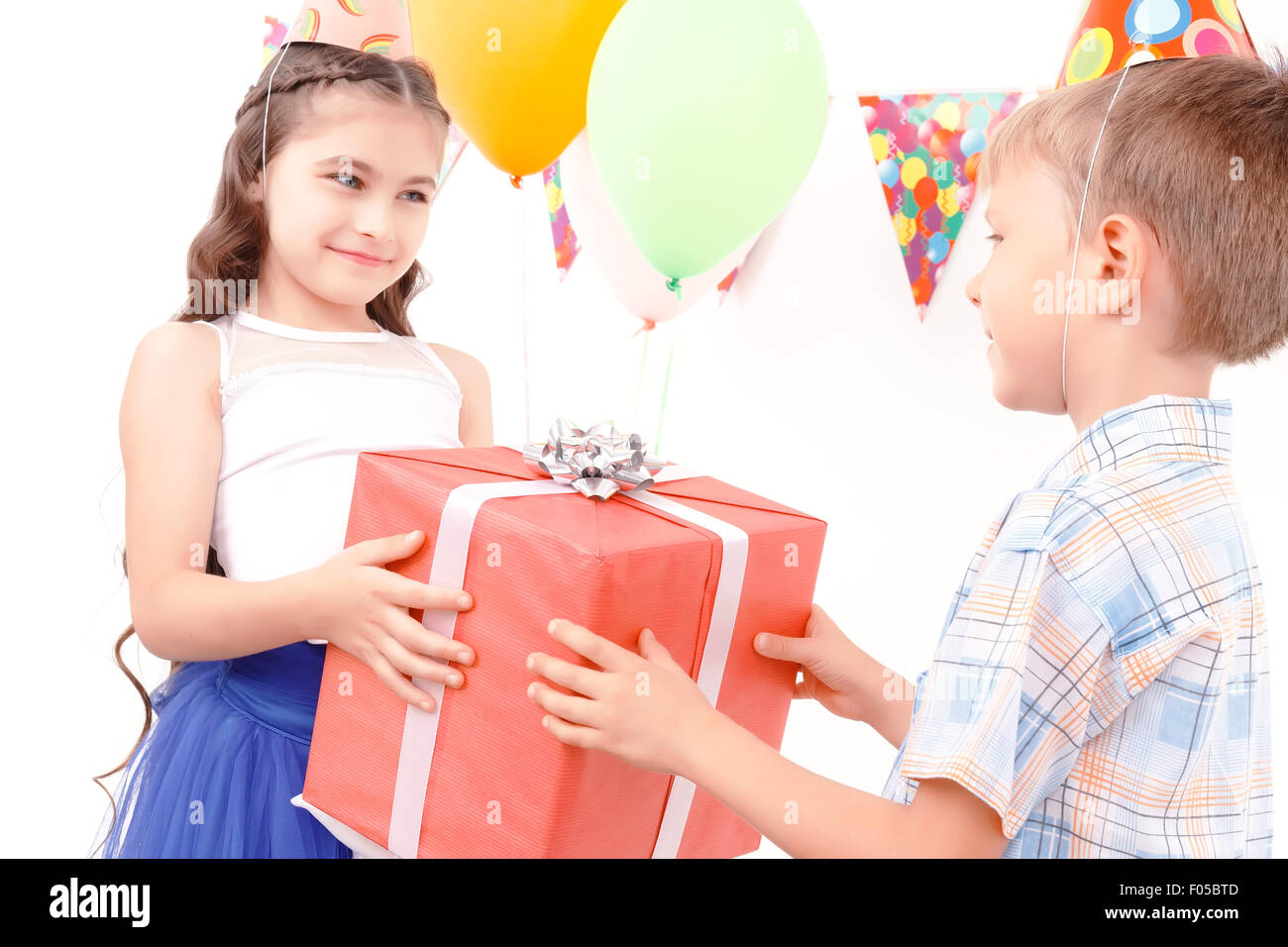 Boy and girl giving present to each other Stock Photo - Alamy