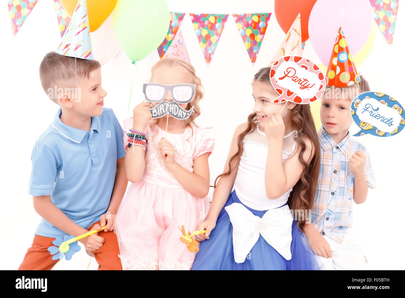 Children holding little birthday tags Stock Photo - Alamy
