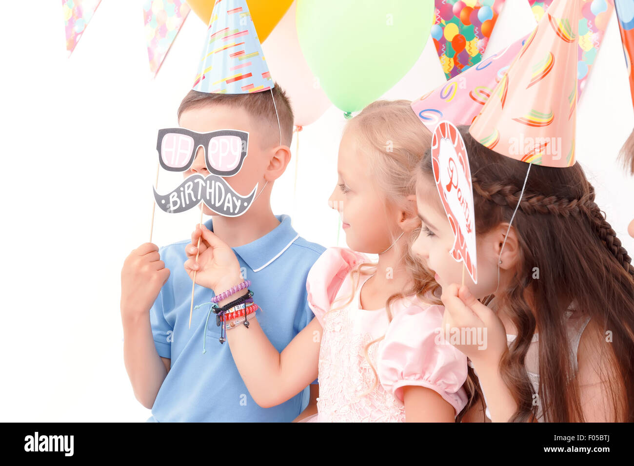 Children holding little birthday tags Stock Photo - Alamy