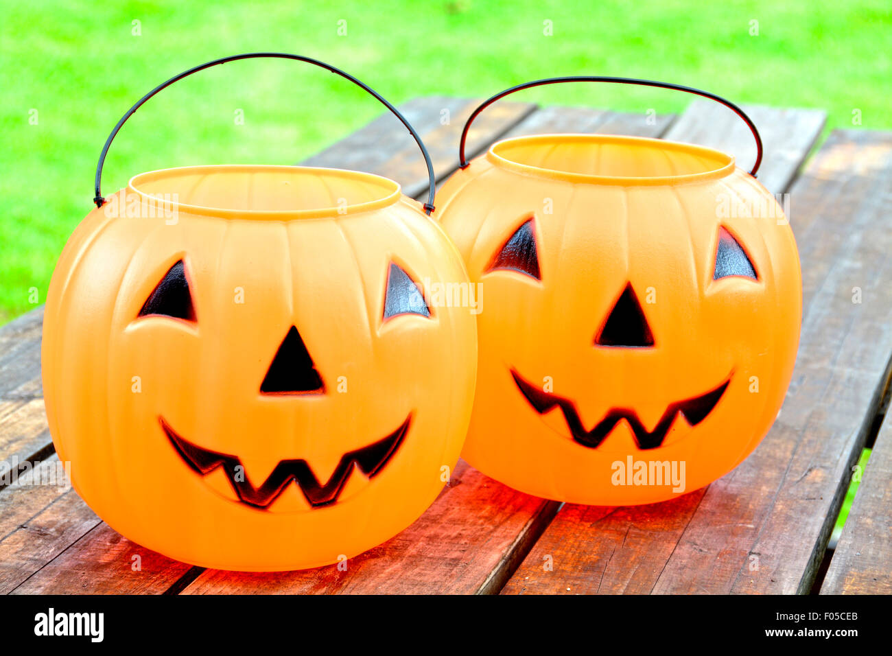 Two empty plastic pumpkins on a table after halloween Stock Photo - Alamy