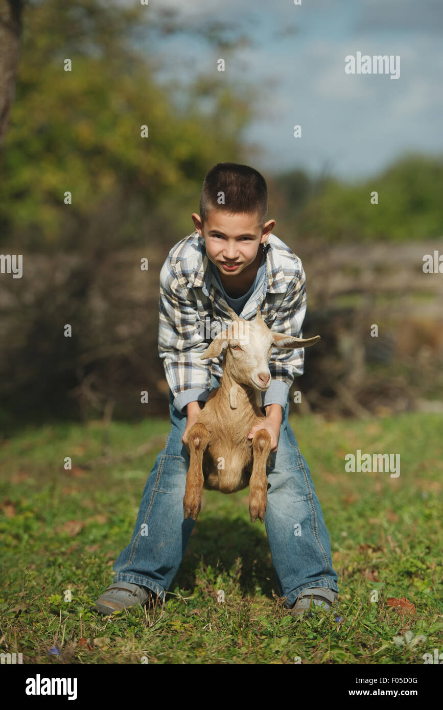 Boy with goat grass hi-res stock photography and images - Alamy