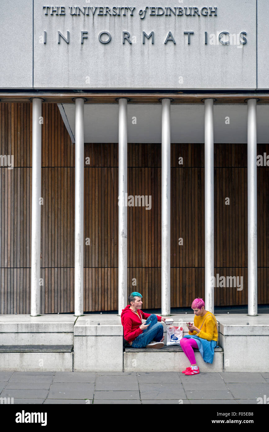 Two brightly coloured students sitting outside the University of ...