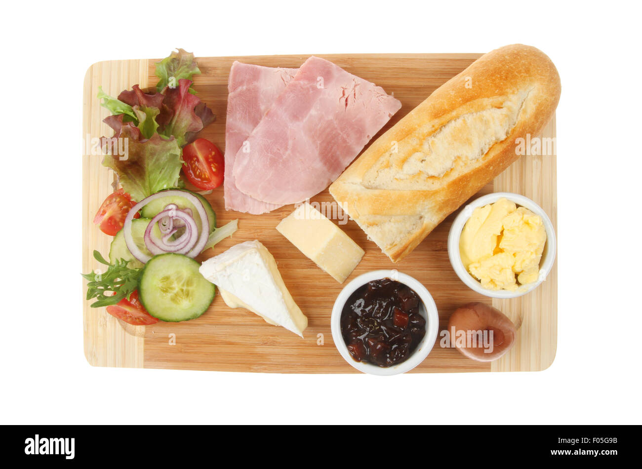 Ham and cheese ploughman's lunch on a wooden platter viewed from above ...
