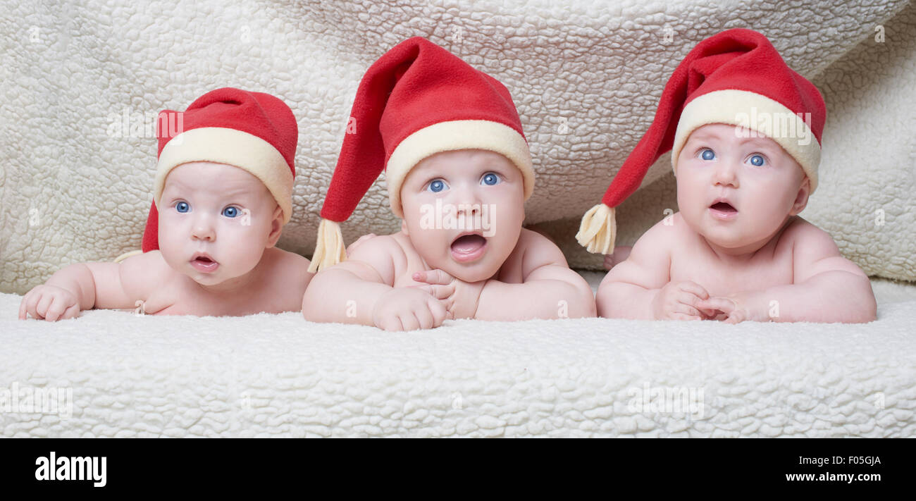babies with santa hats on bright background Stock Photo - Alamy