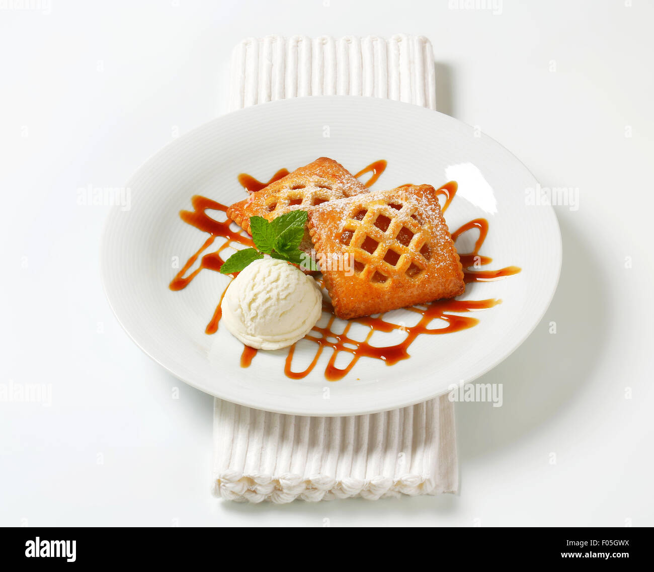 Little apricot pies with ice cream and drizzle sauce Stock Photo - Alamy