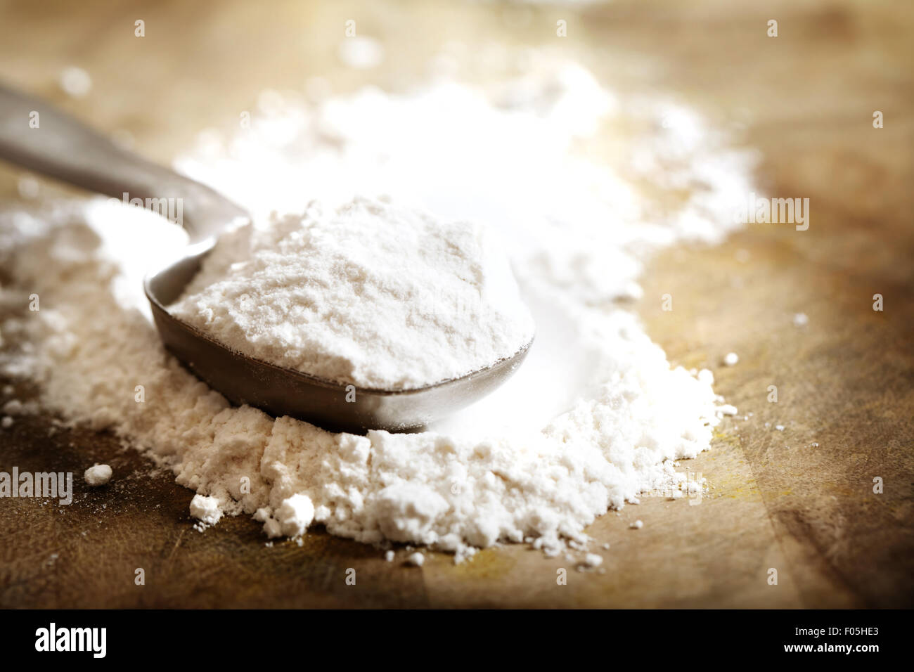 Flour in measuring spoon on rustic wooden board Stock Photo - Alamy
