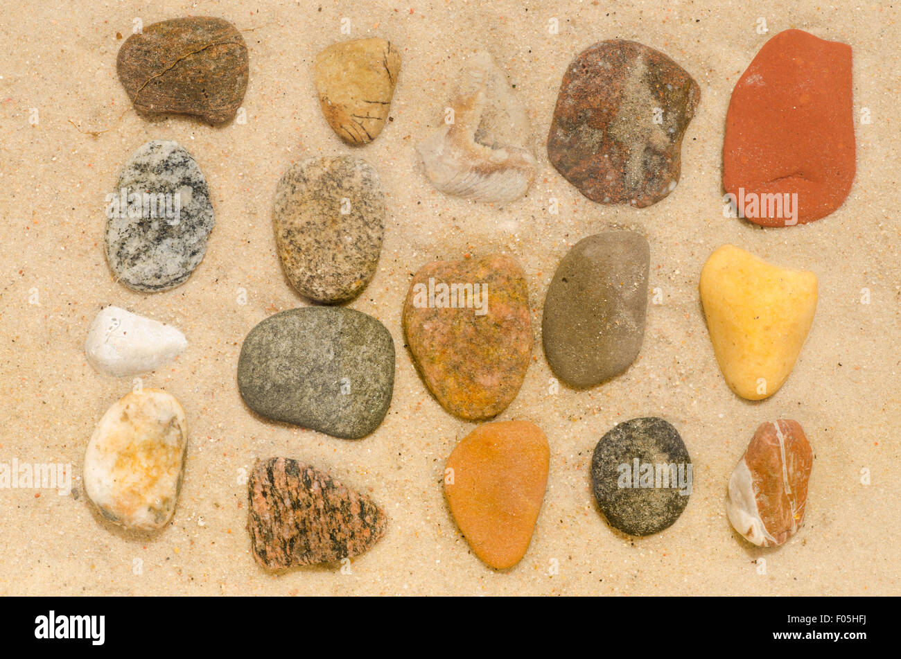 pebbles composition sand background Stock Photo - Alamy