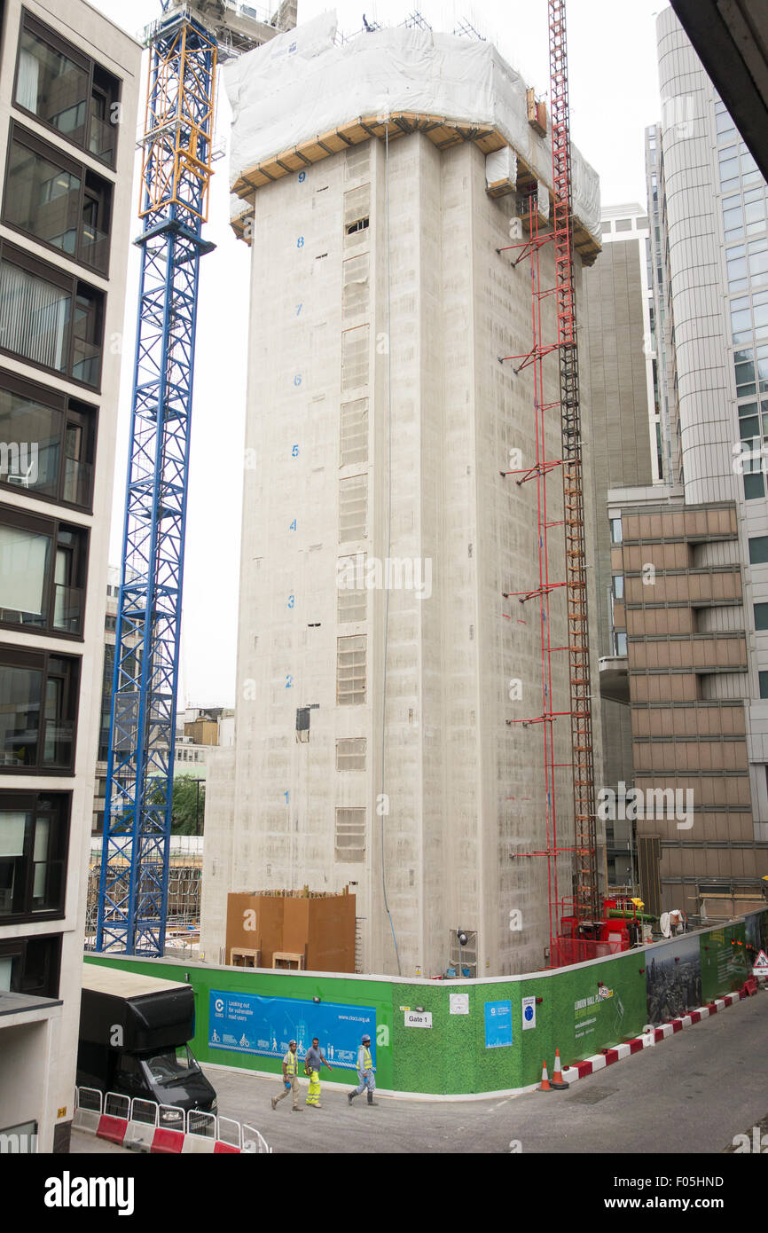 Workmen walking around the construction of a new commercial building at ...